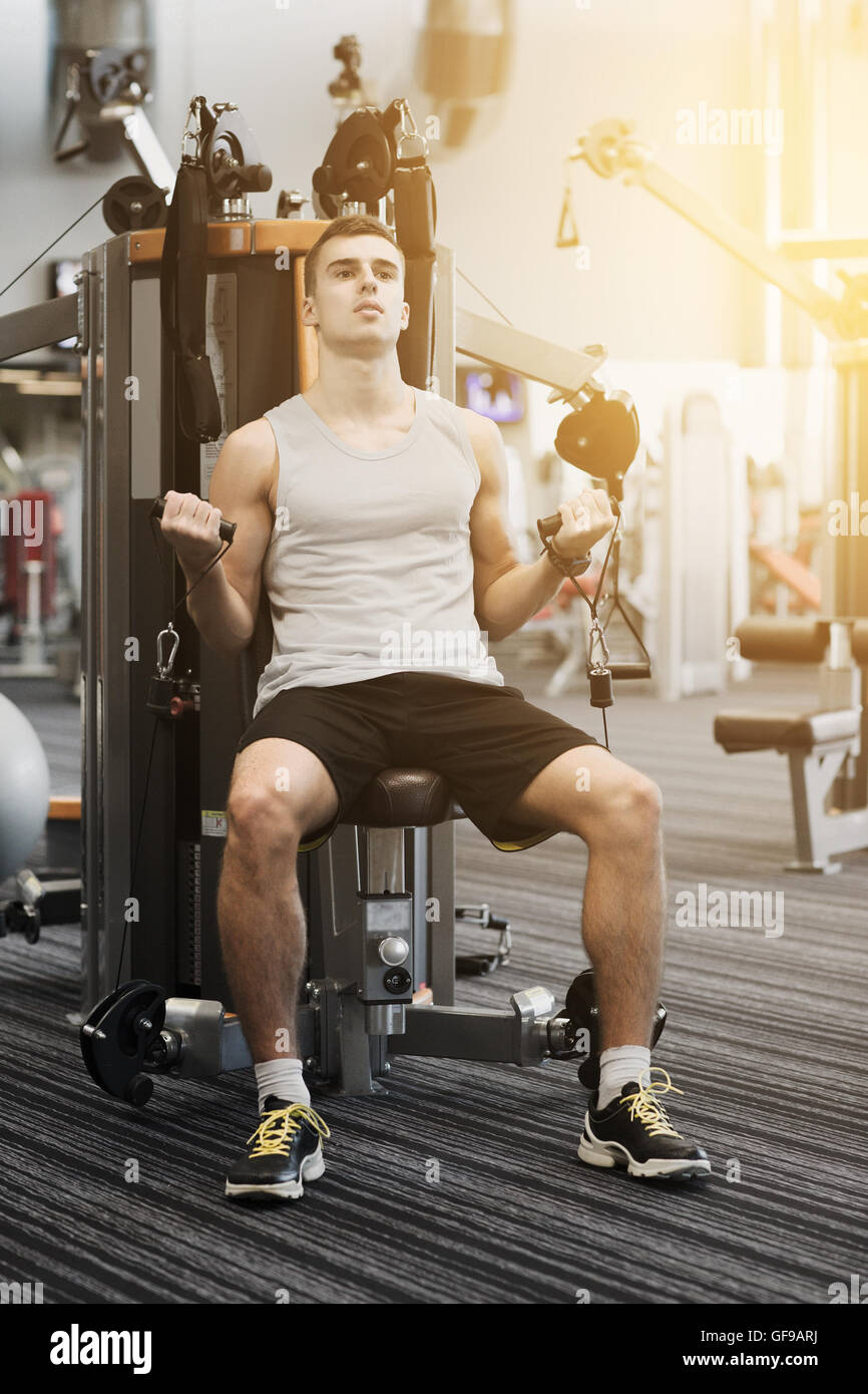 man exercising on gym machine Stock Photo - Alamy