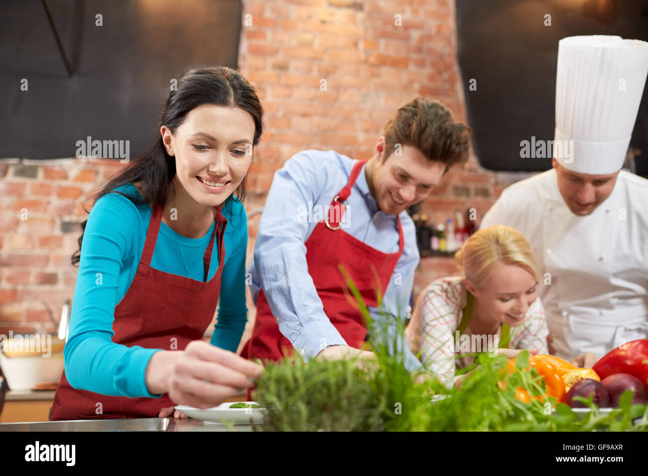 happy friends and male chef cooking in kitchen Stock Photo - Alamy