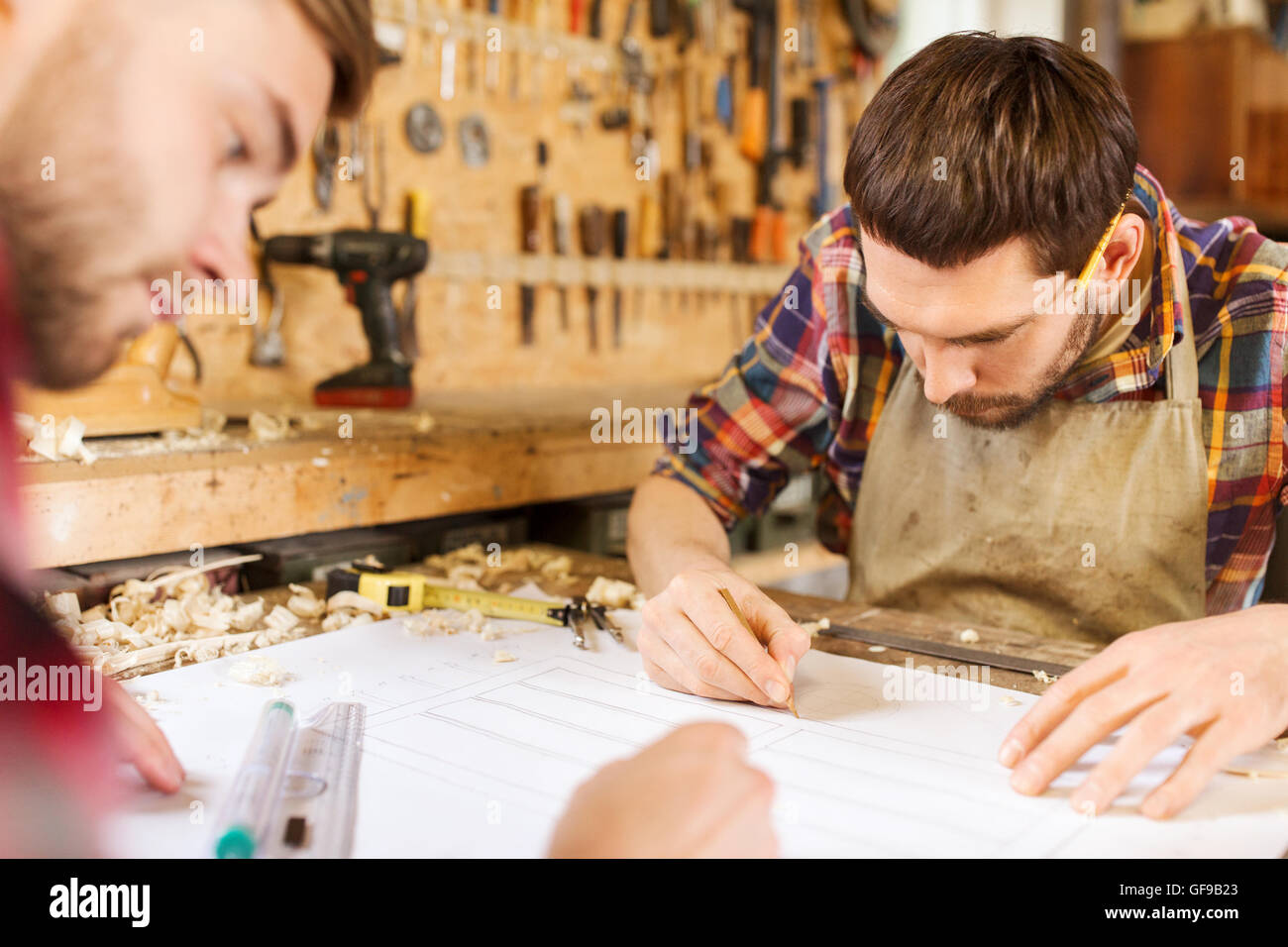 carpenters with ruler and blueprint at workshop Stock Photo - Alamy