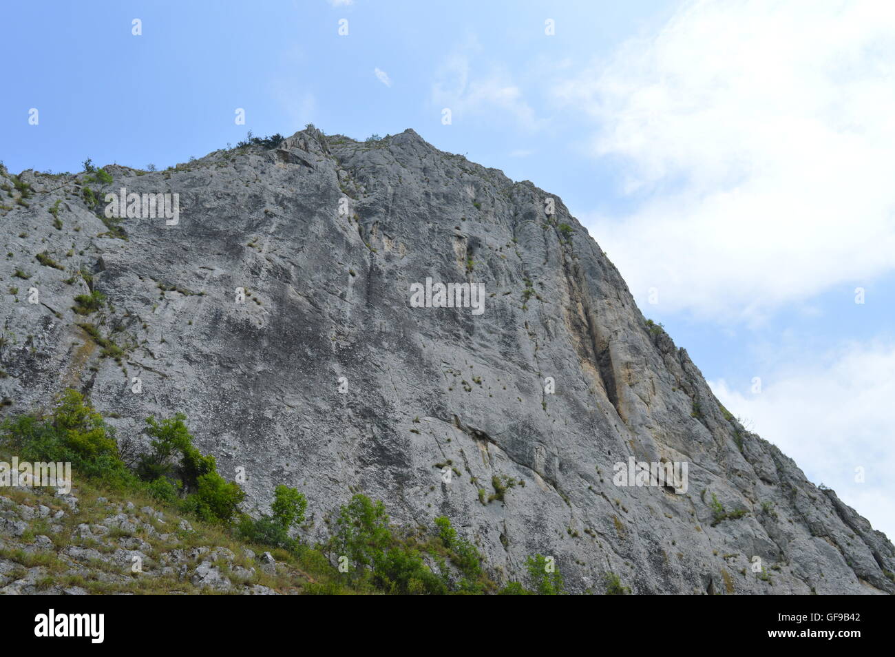 View from the bottom of a steep rock Stock Photo - Alamy