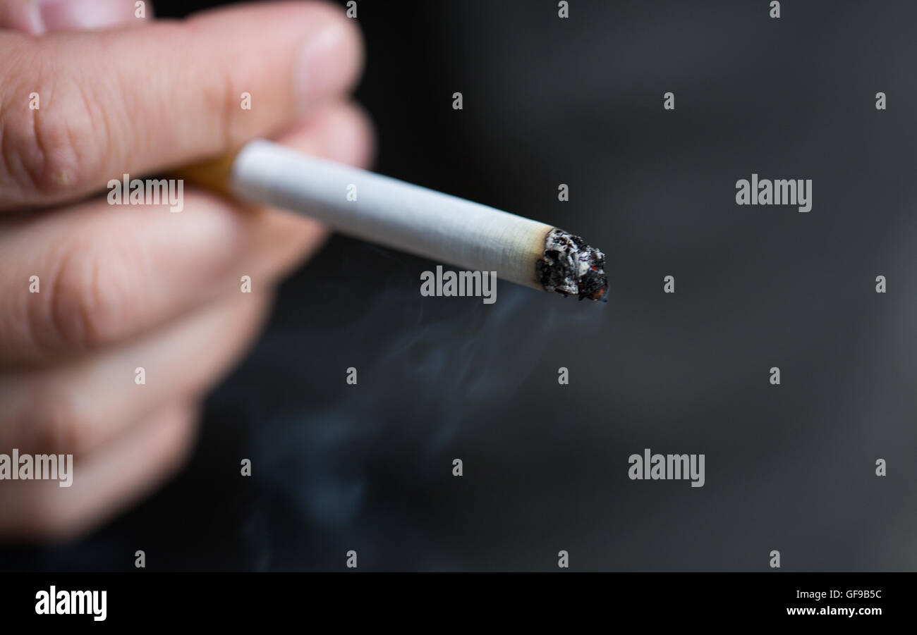 close up of male hand with smoking cigarette Stock Photo - Alamy