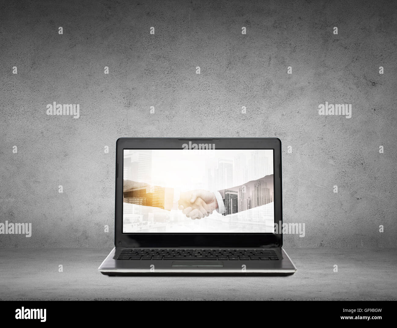 laptop computer with handshake on screen Stock Photo - Alamy