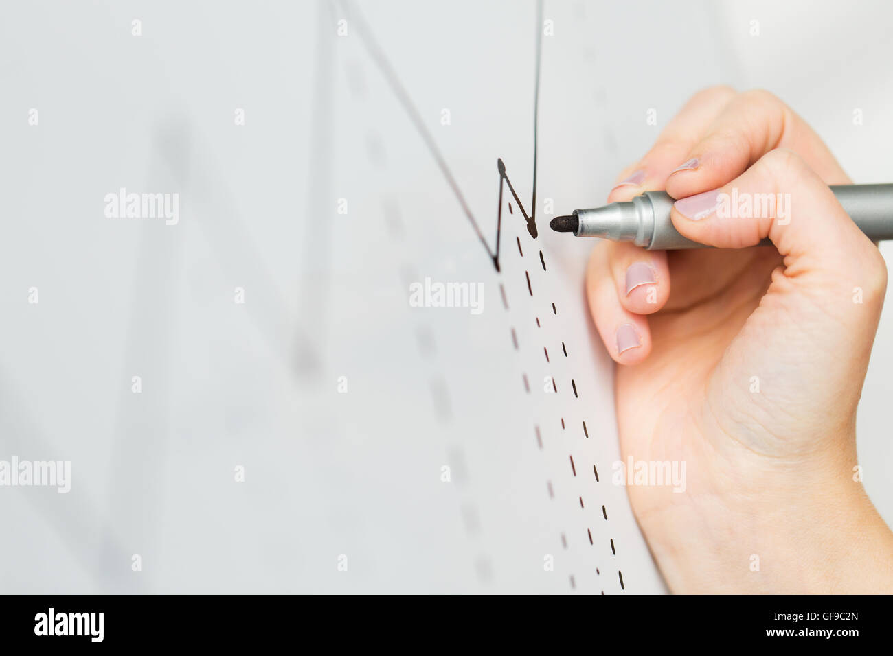 close up of hand drawing graph on white board Stock Photo - Alamy