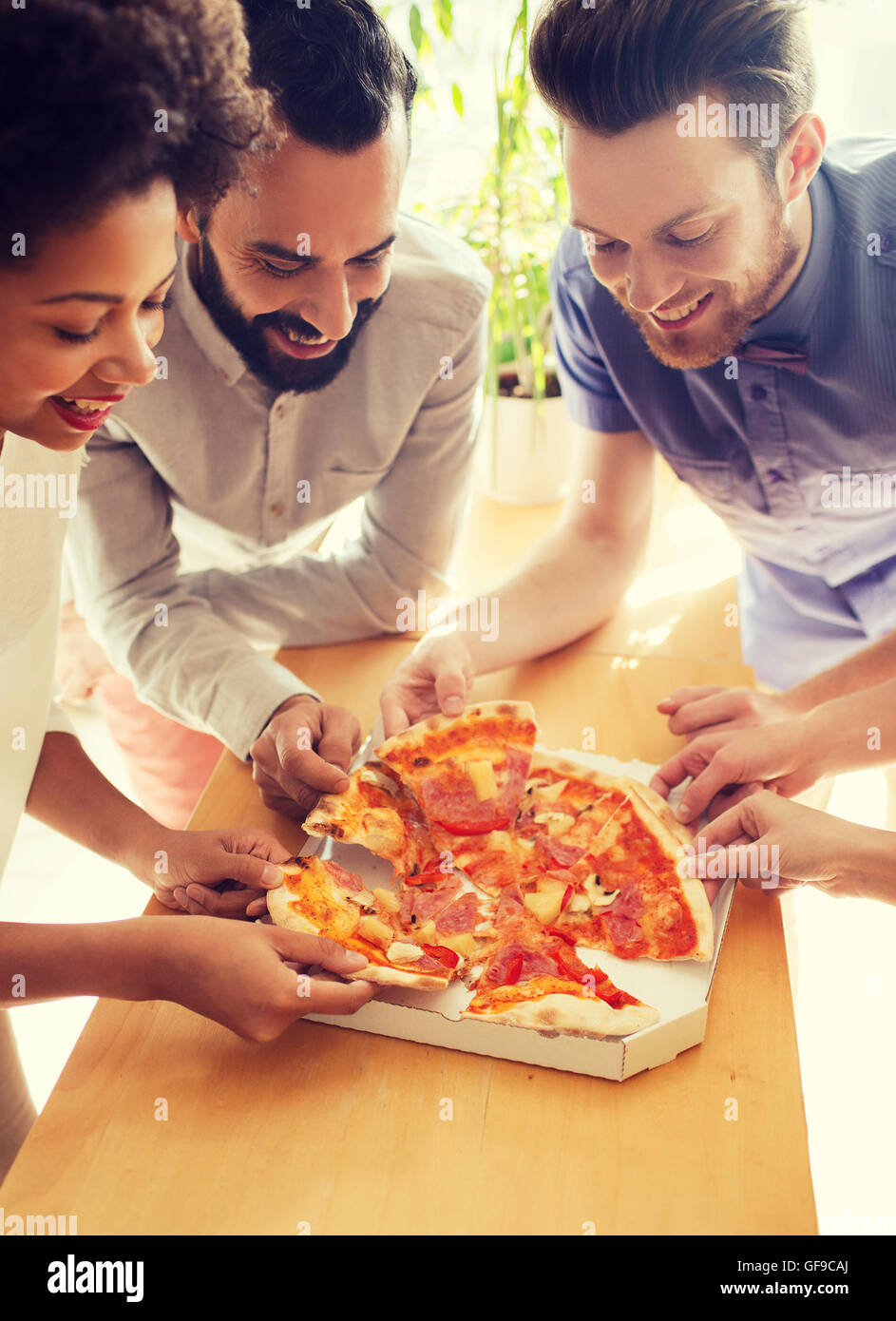 happy business team eating pizza in office Stock Photo - Alamy
