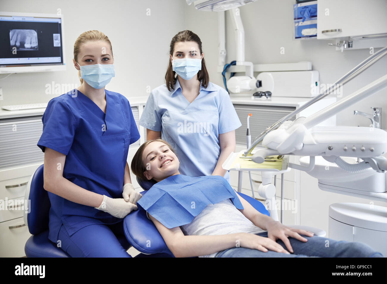 happy female dentist with patient girl at clinic Stock Photo - Alamy