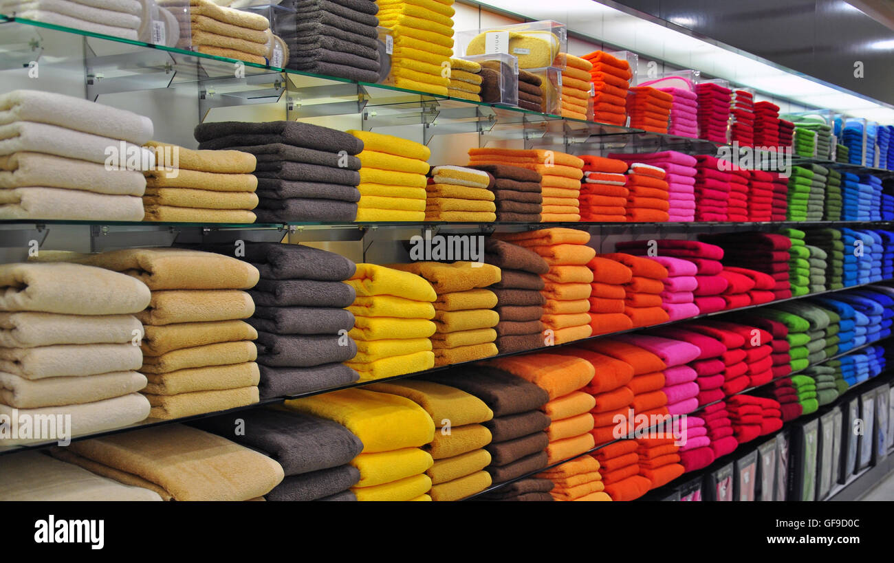 Multicolor towels in the shop Stock Photo - Alamy