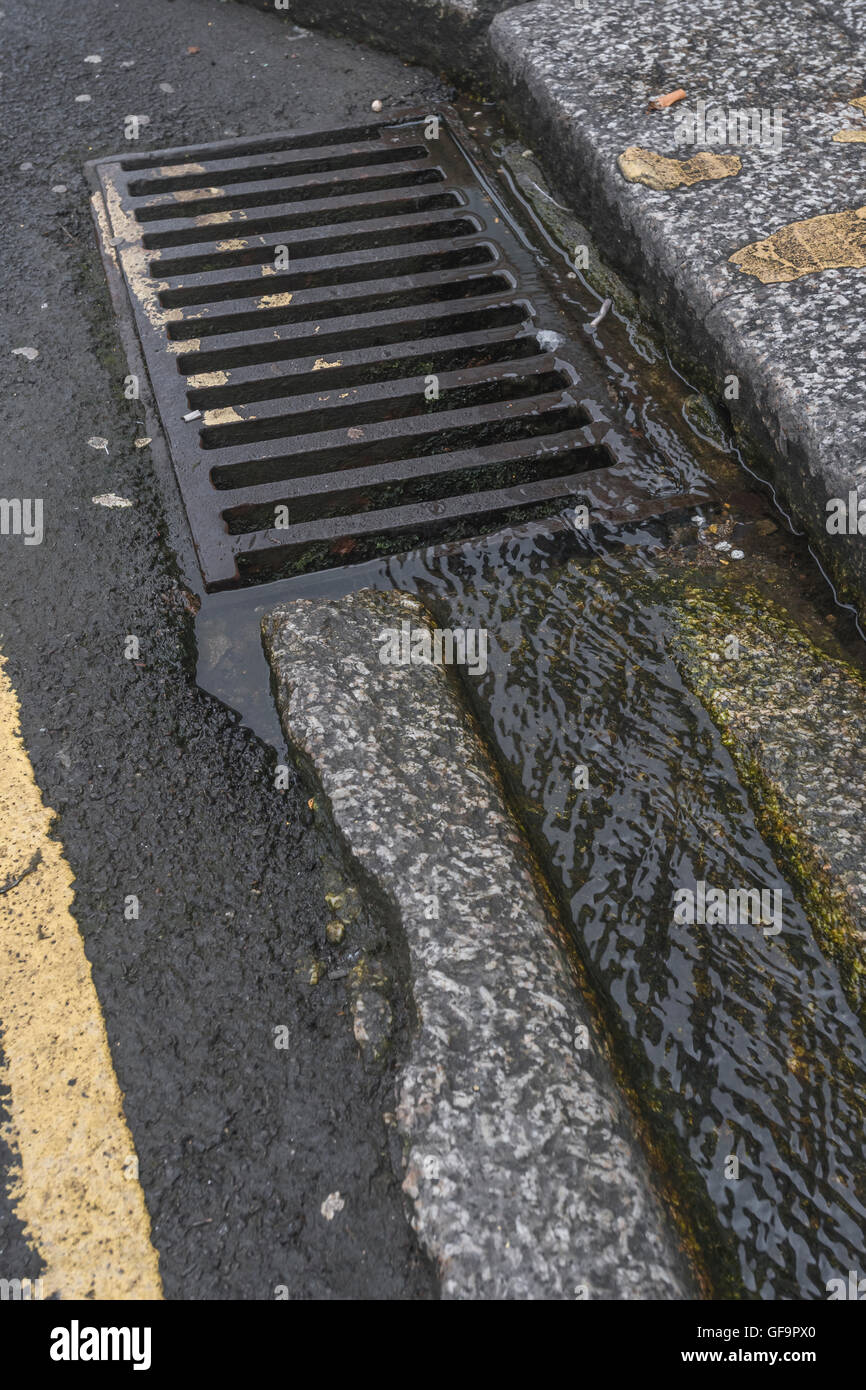 Street drainage / gutter in Truro, Cornwall. Visual metaphor for 'money ...