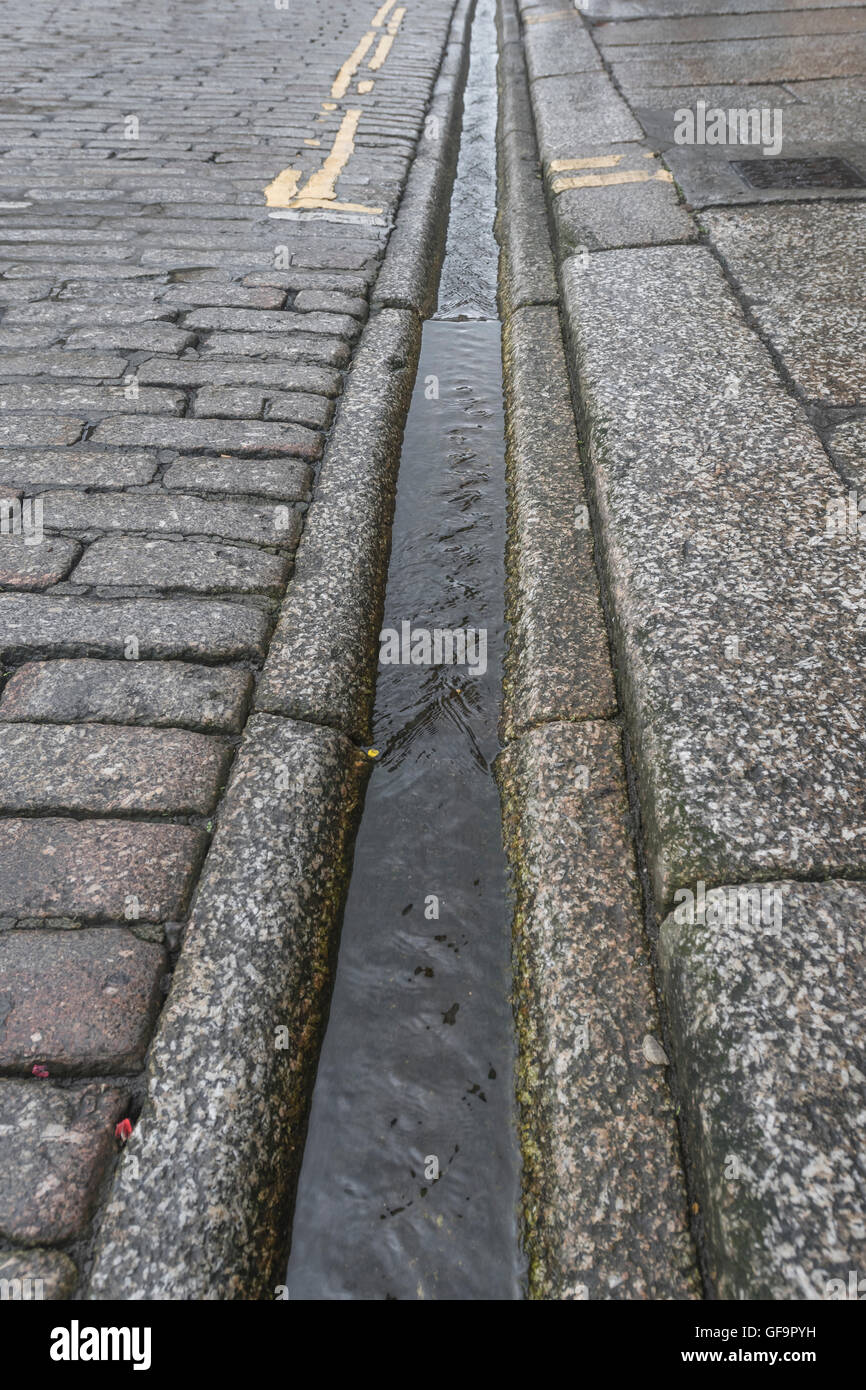 Street drainage / gutter in Truro, Cornwall. Visual metaphor for 'money ...