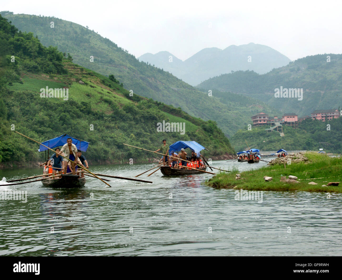 Boatmen of the Tujia minority steer sampans “pea boats” carrying ...