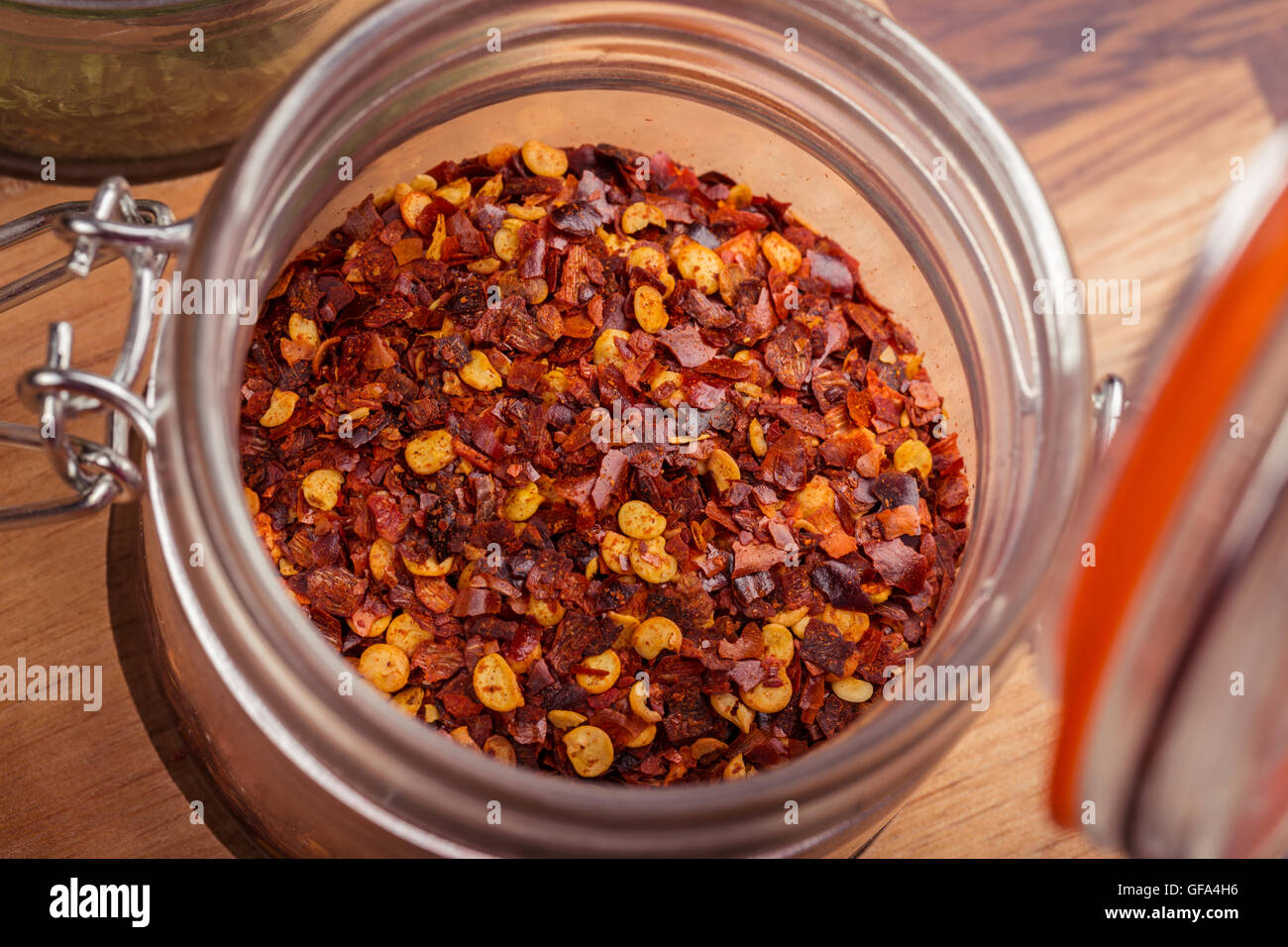 Red chilli flakes in a glass jar Stock Photo - Alamy