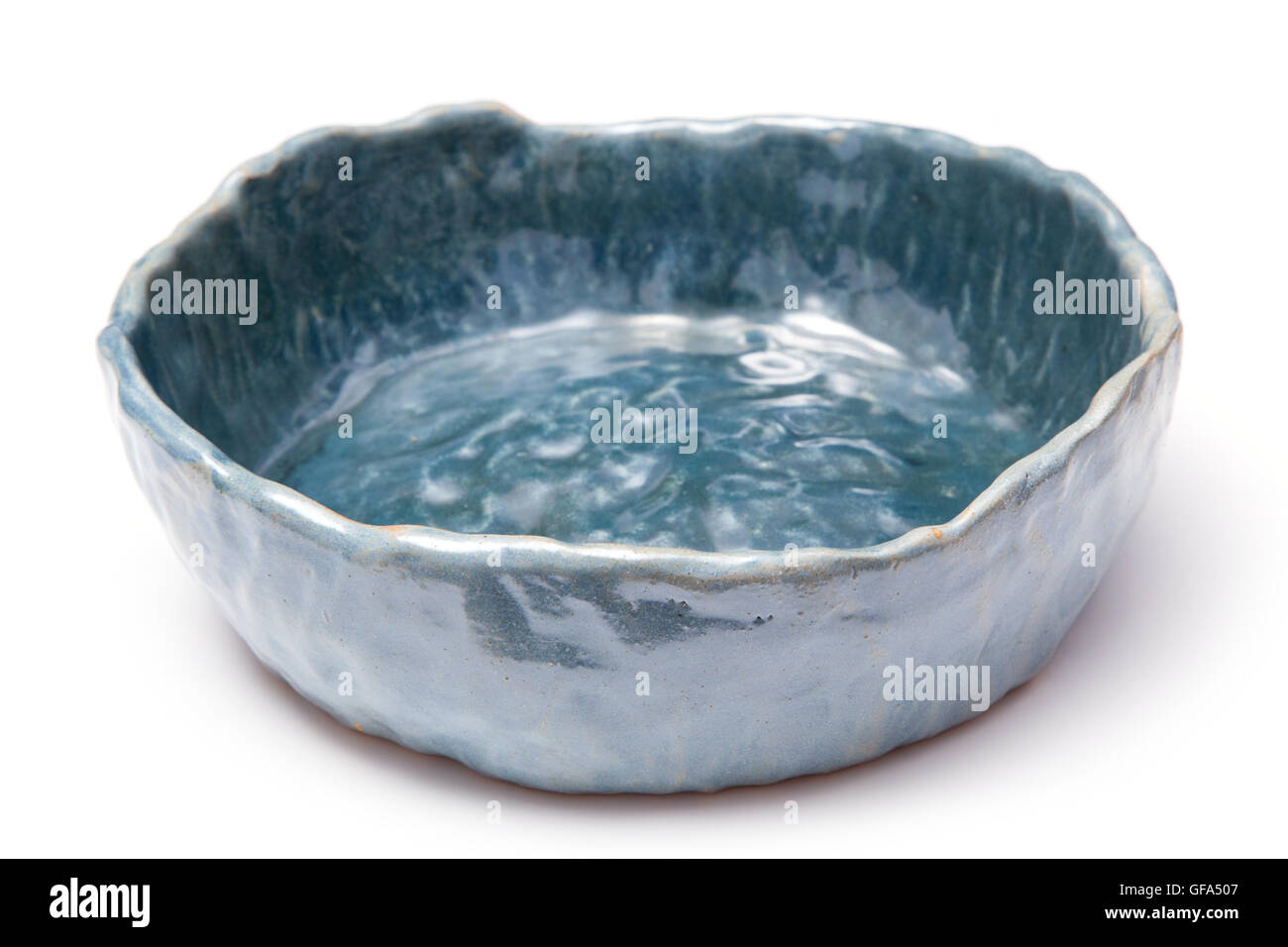 Hand made ceramic pinch pot ceramic bowl isolated on a white studio ...