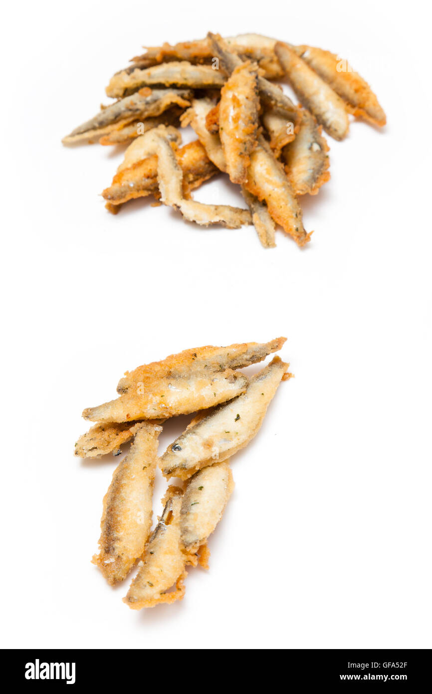 Battered whitebait sprats (Sprattus sprattus) isolated on a white ...
