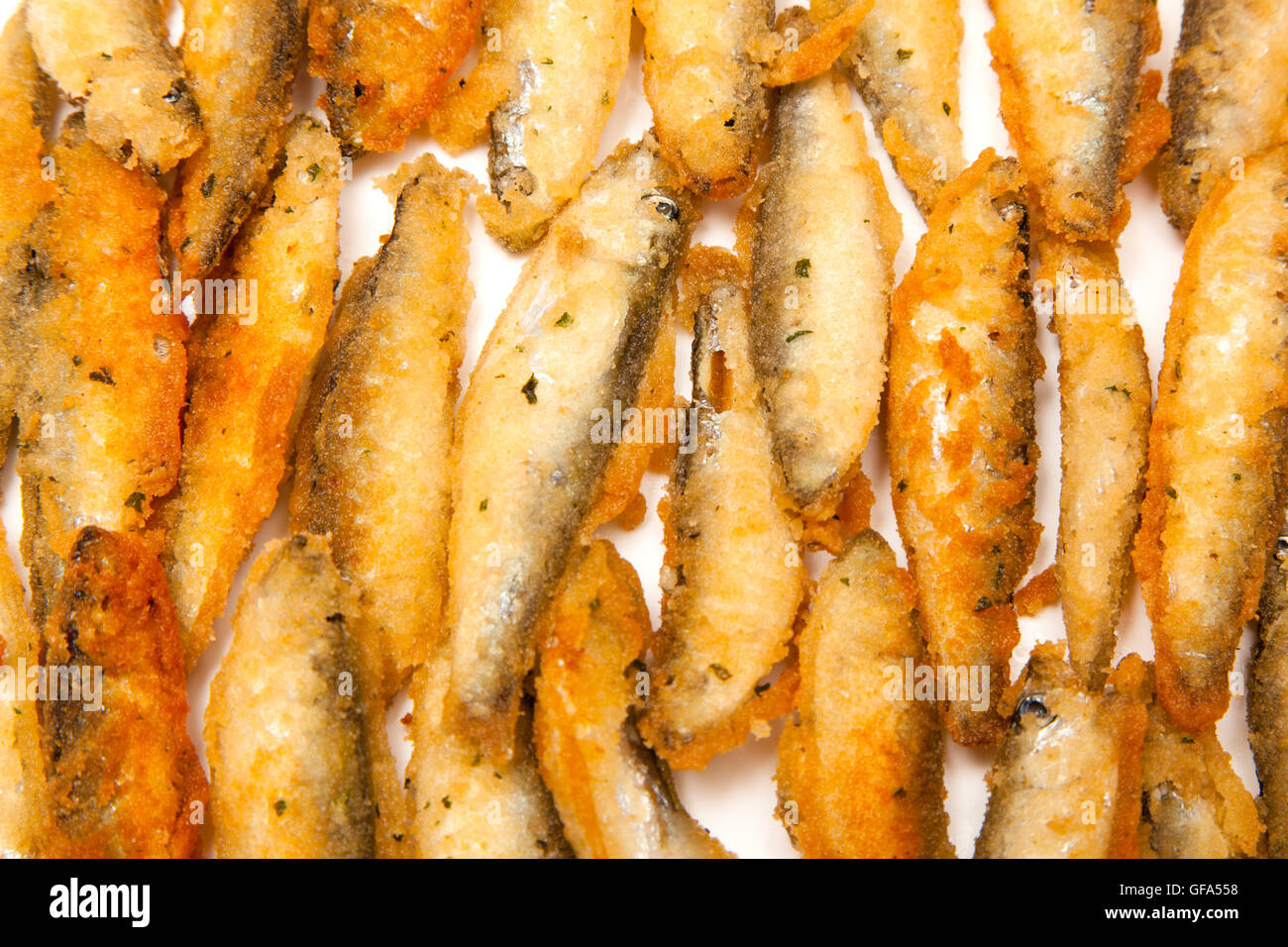 Battered whitebait sprats (Sprattus sprattus) isolated on a white ...