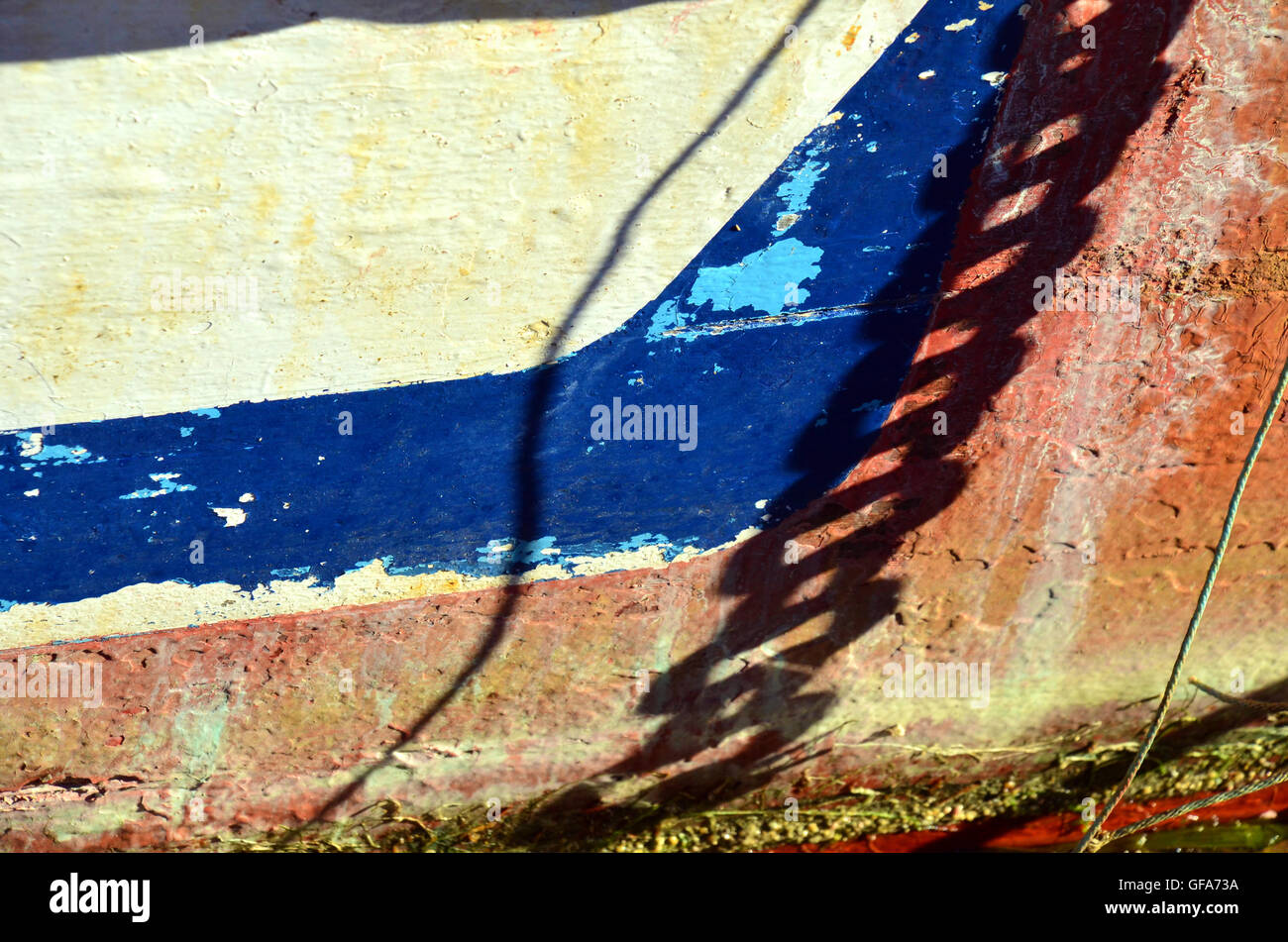 Detail of paint on side of boat with shadow of anchor chain Stock Photo ...