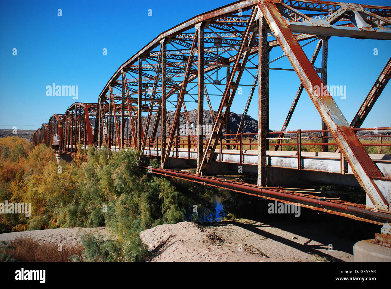 Rusty old steel bridge crossing river in southwest desert Stock Photo ...
