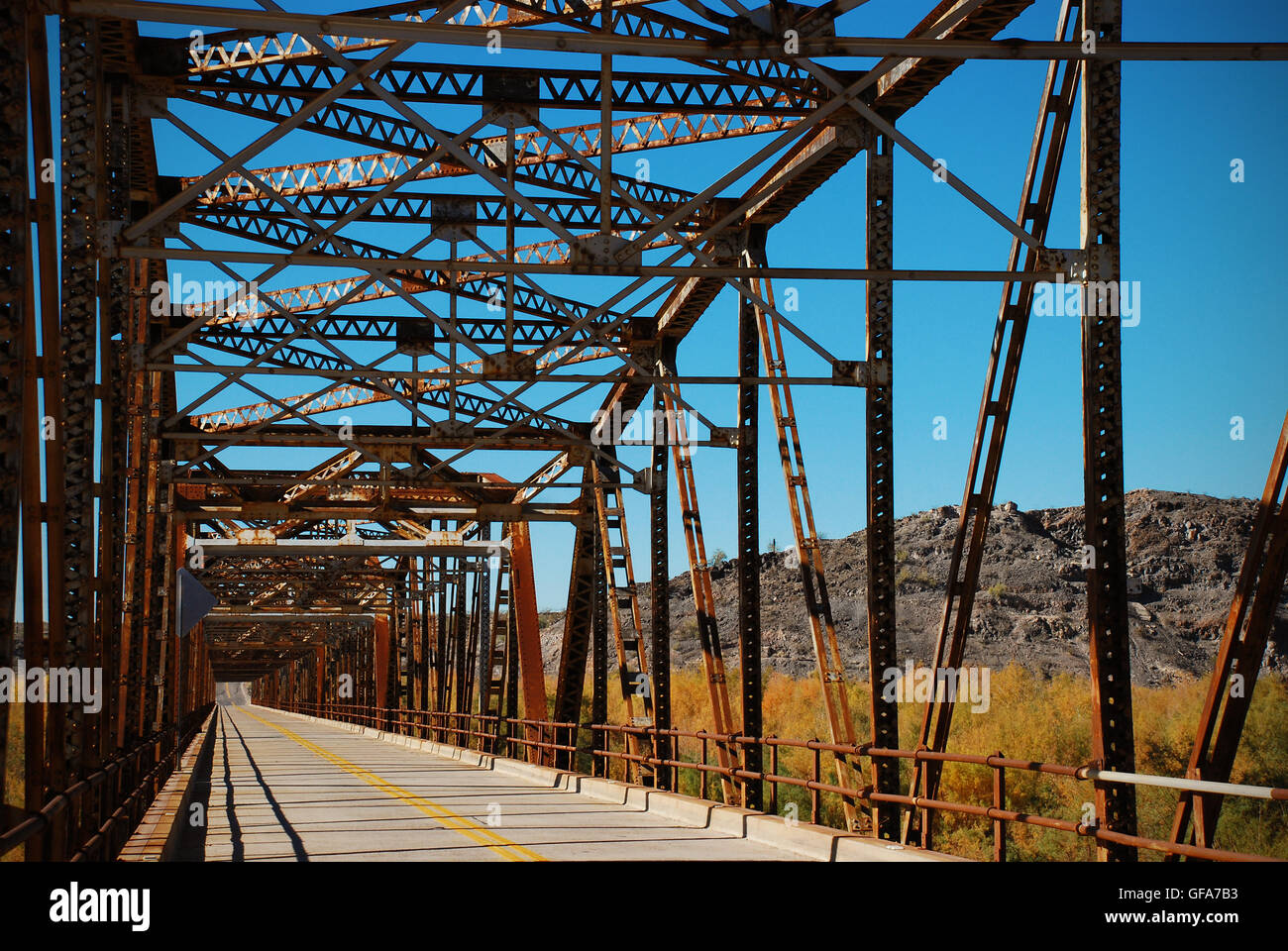 Rusty old steel bridge crossing river in southwest desert Stock Photo ...