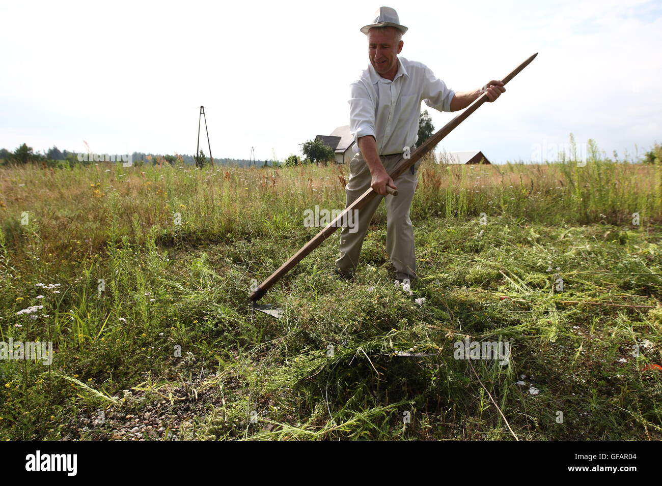 Farmer using scythe hi-res stock photography and images - Alamy