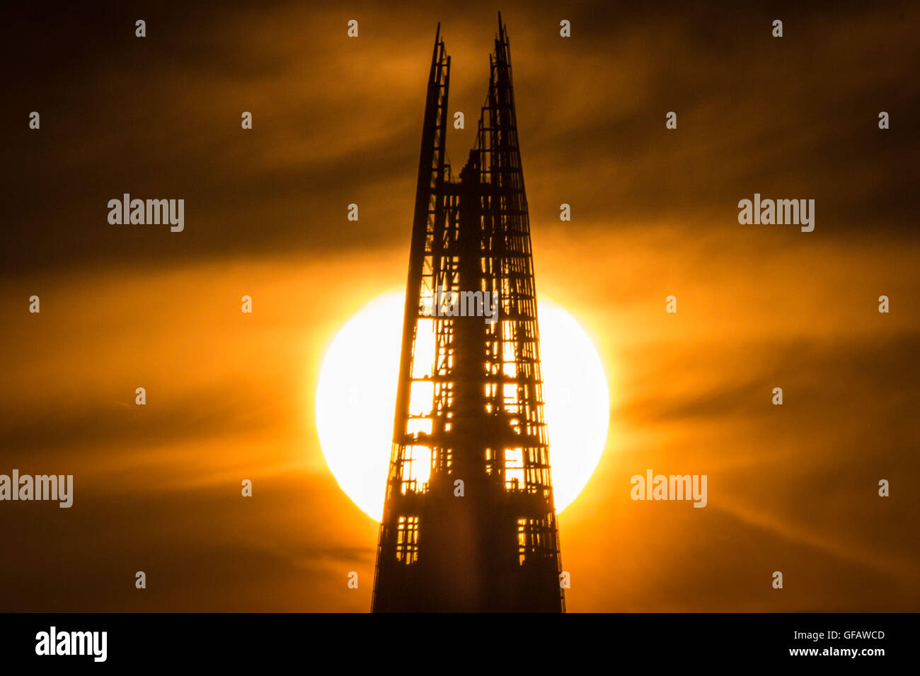 London, UK. 30th July, 2016. Split sunset behind The Shard building in ...