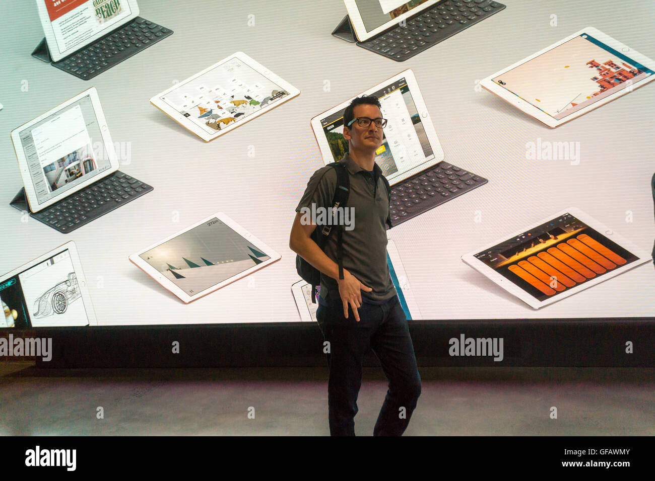 Apple enthusiasts pass a video wall in Williamsburg, Brooklyn in New ...