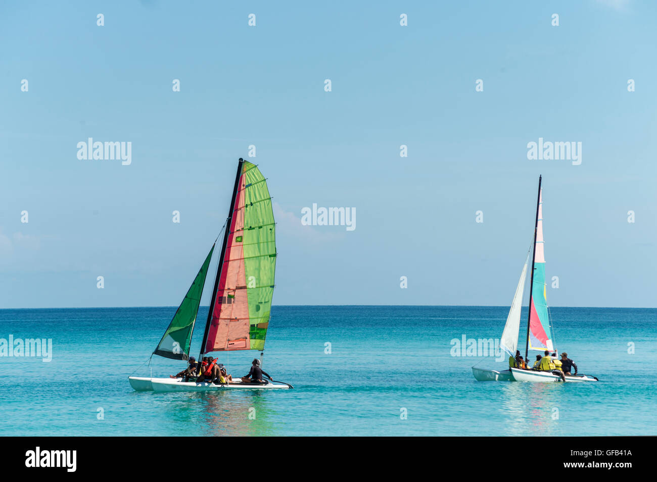 two sailboats sailing on the turquoise waters of the Caribbean Stock ...