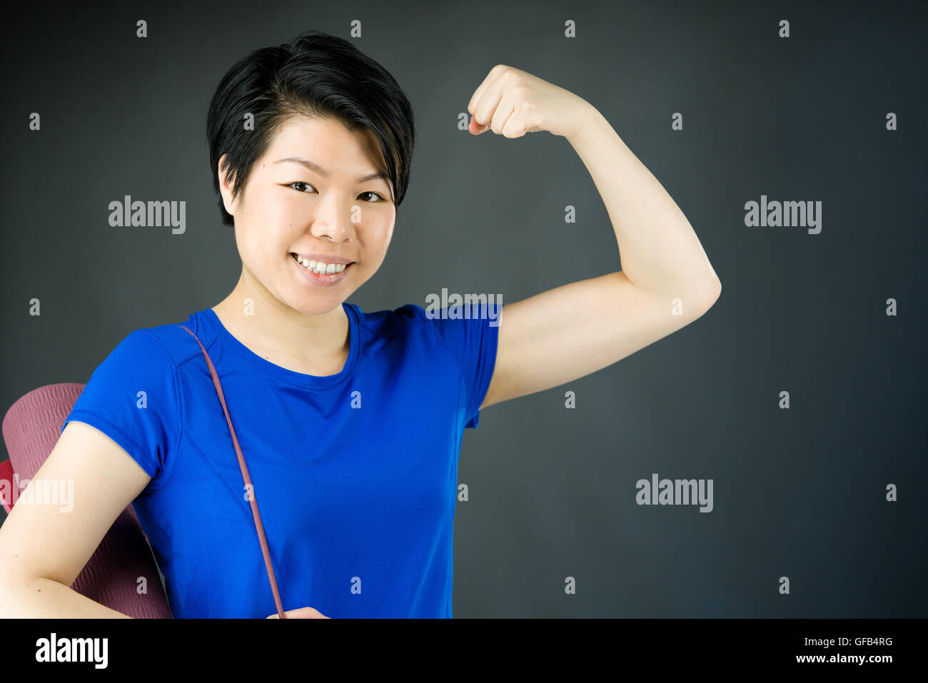 female model attractive woman showing strength with arm curl Stock ...