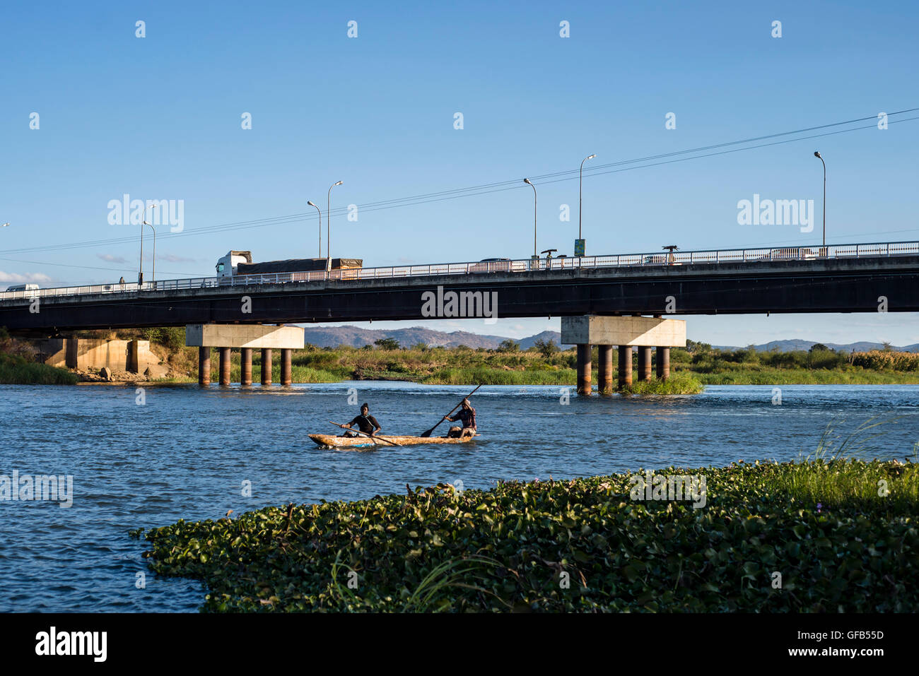 Men rowing in a handmade wooden kayak on Kafue river, Kafue, Zambia ...