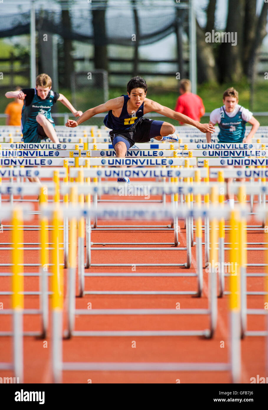 Male high school students compete in hurdles event at the Southern ...