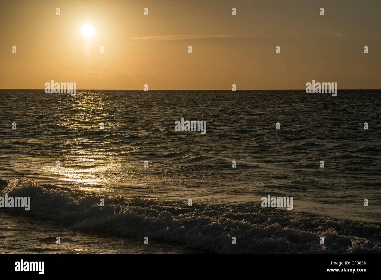 sunset in the Caribbean with the sun in picture Stock Photo - Alamy
