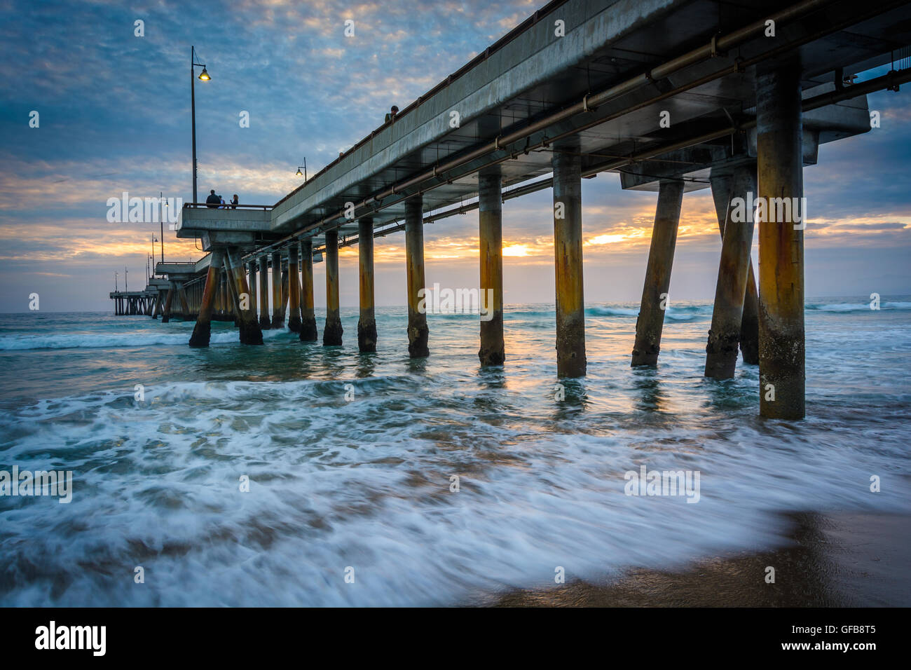 Waves in the Pacific Ocean and the pier at sunset, in Venice Beach, Los ...