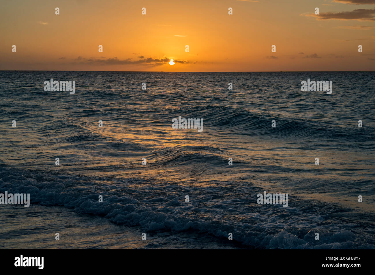 sunset in the Caribbean with the sun in picture Stock Photo - Alamy