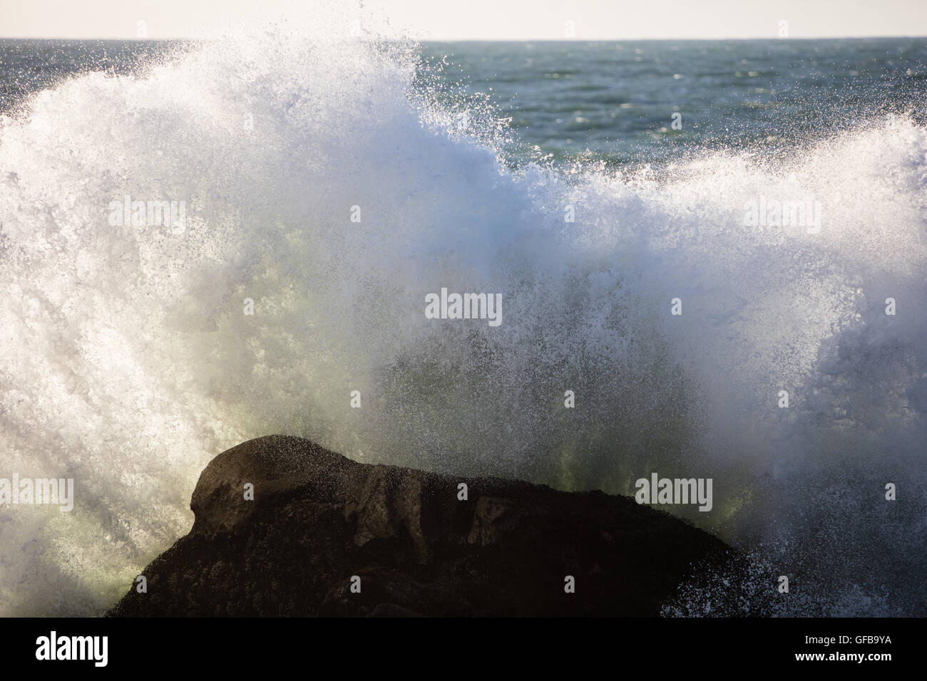 Powerful waves from the Pacific Ocean crash against rocks on the ...