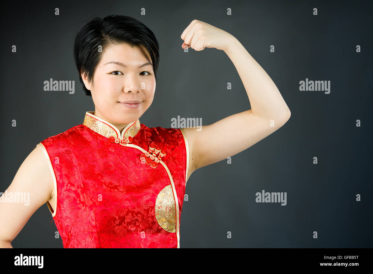 female model attractive woman showing strength with arm curl Stock ...