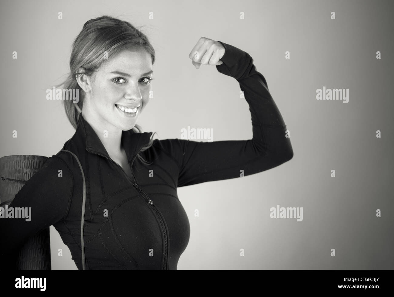 female model attractive woman showing strength with arm curl Stock ...