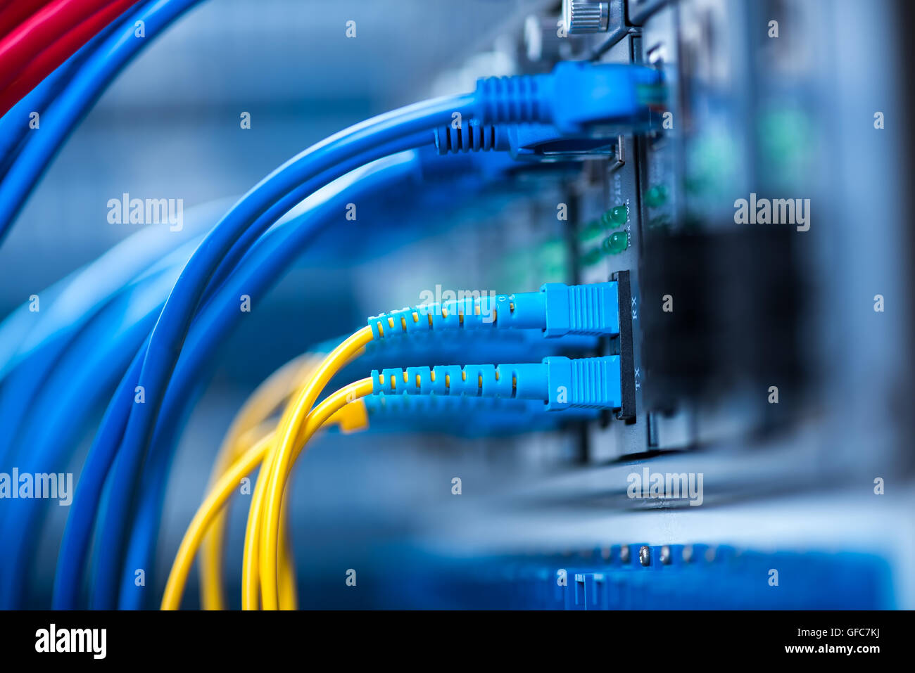 Fiber network switch with some yellow optical network cables Stock ...