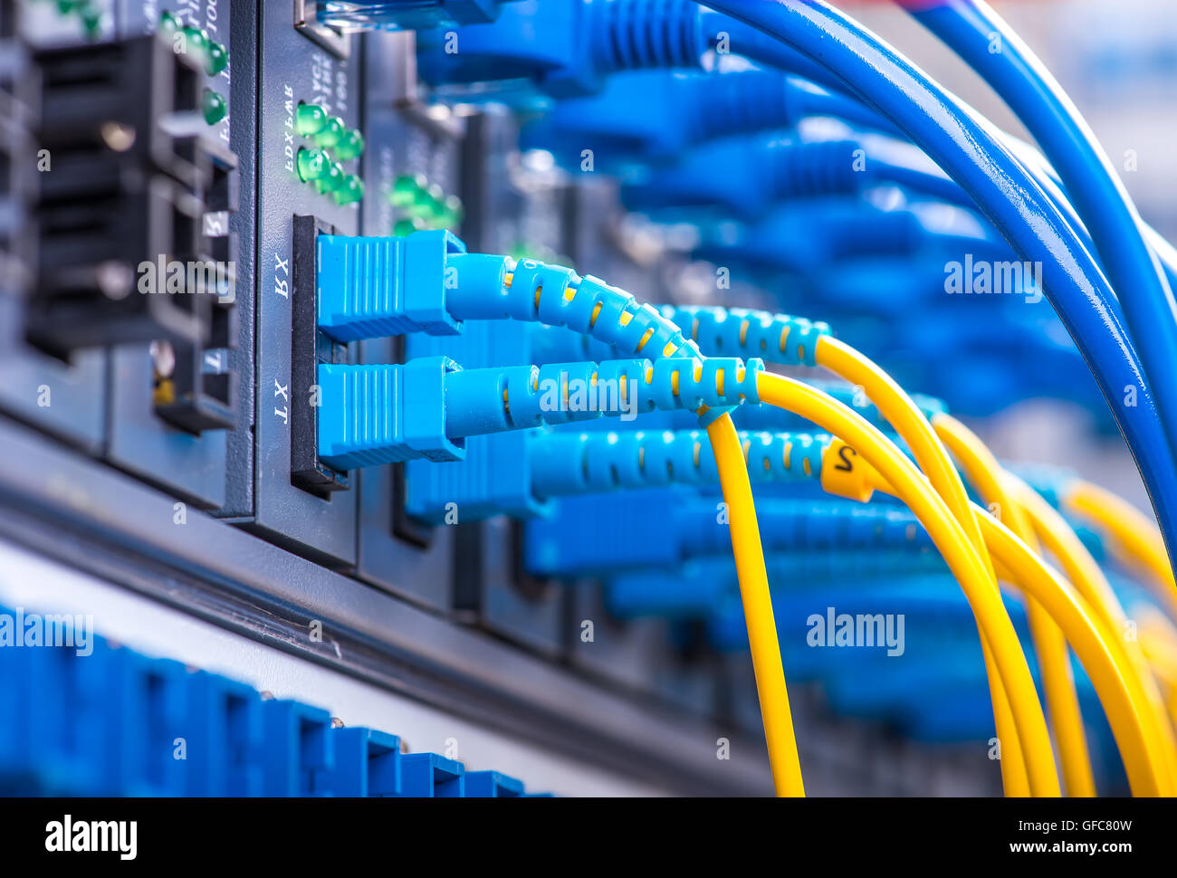 Fiber network switch with some yellow optical network cables Stock ...