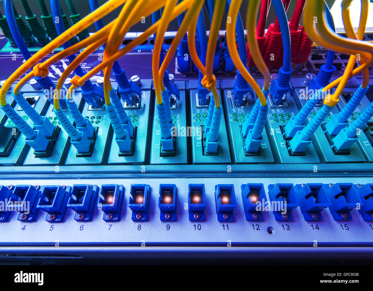 Fiber network switch with some yellow optical network cables Stock ...