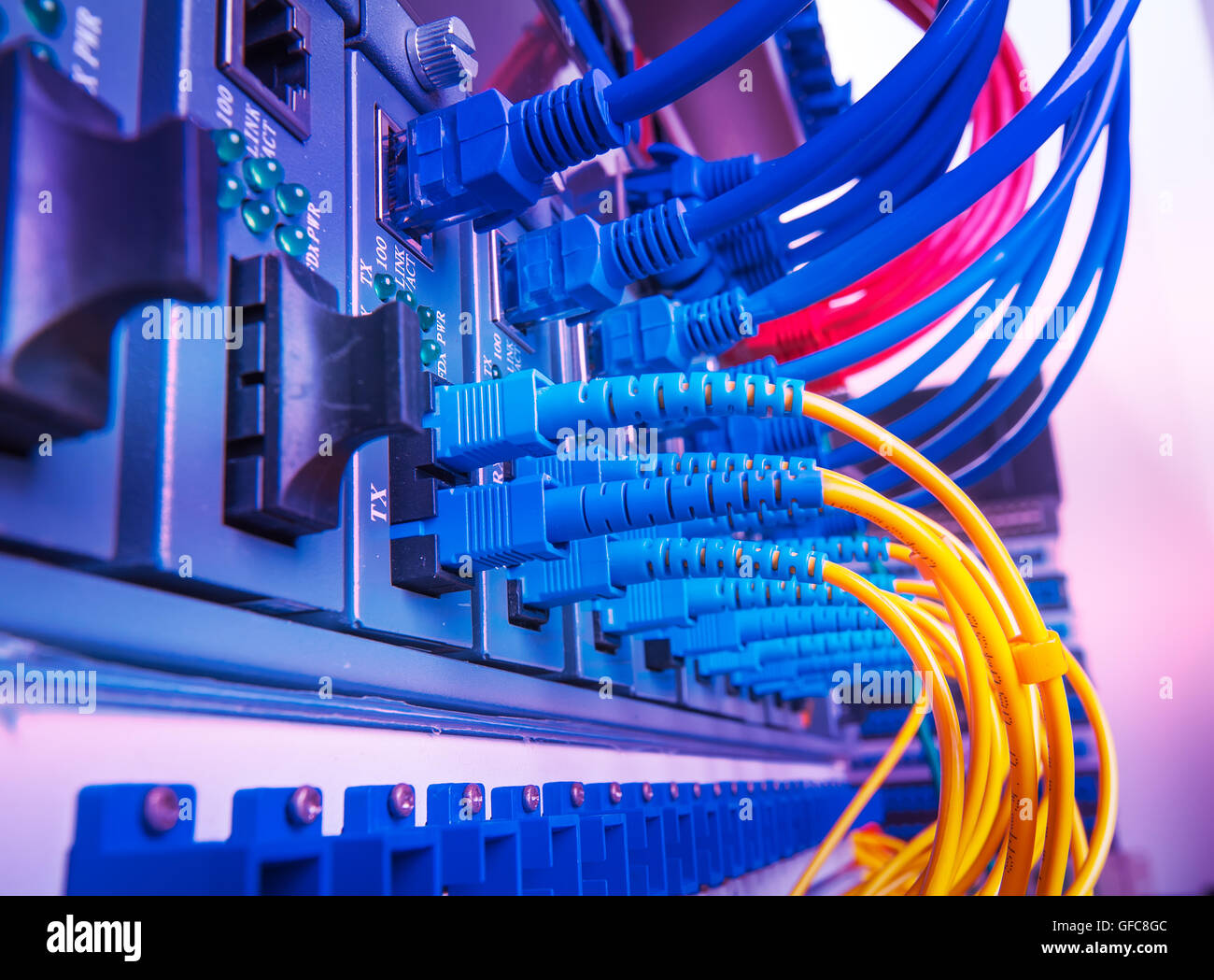 Fiber network switch with some yellow optical network cables Stock ...