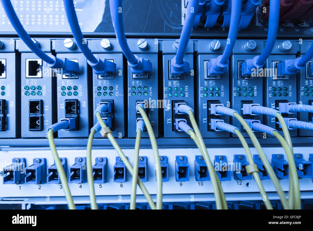 Fiber network switch with some yellow optical network cables Stock ...