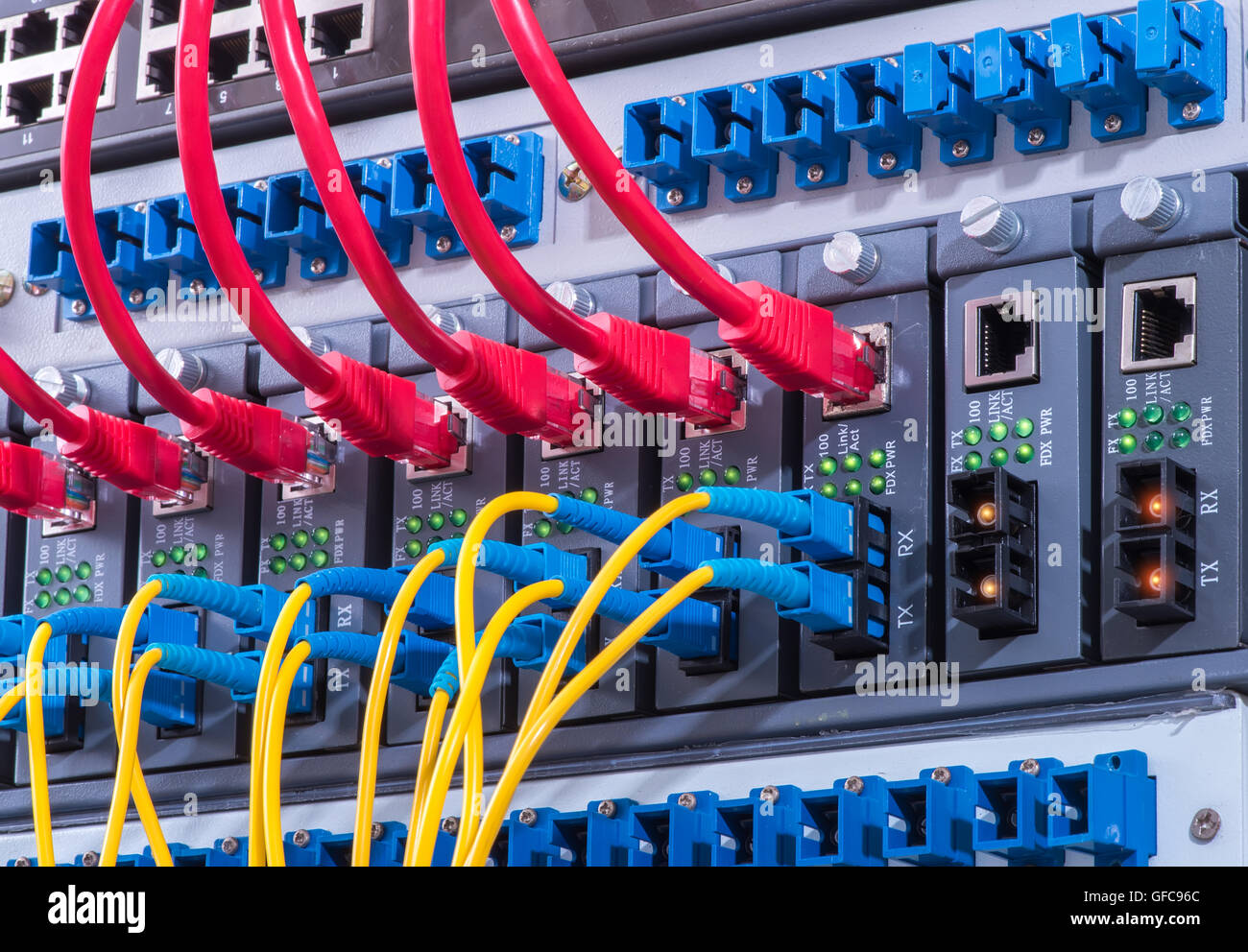 Fiber network switch with some yellow optical network cables Stock ...