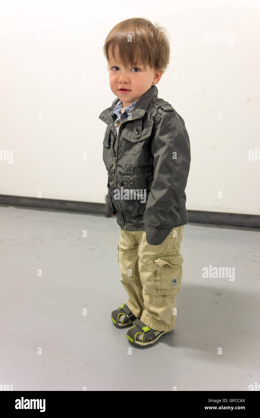 Portrait of a boy standing and smiling Stock Photo - Alamy