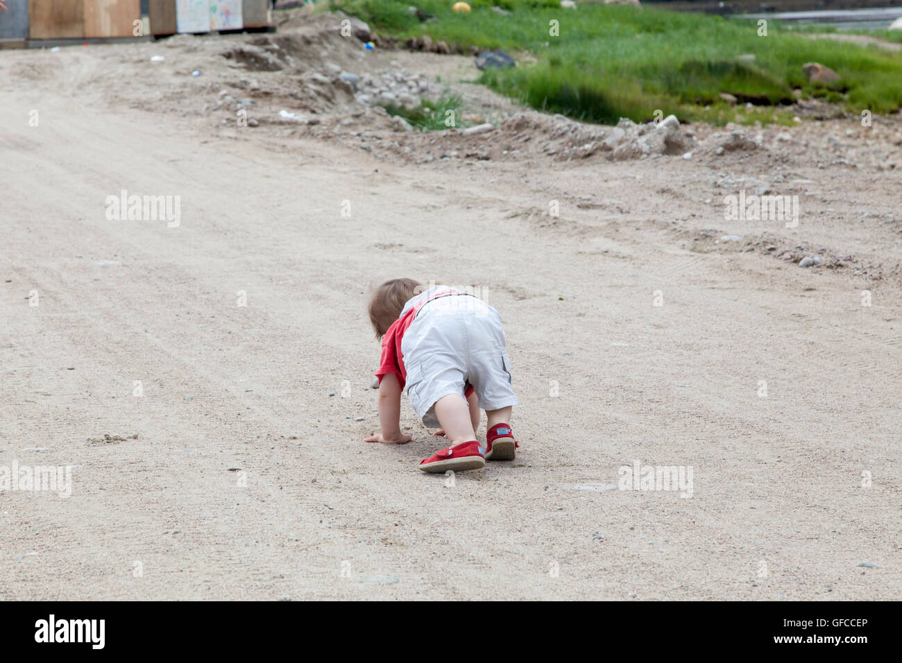 Fallen boy trying to get up Stock Photo - Alamy
