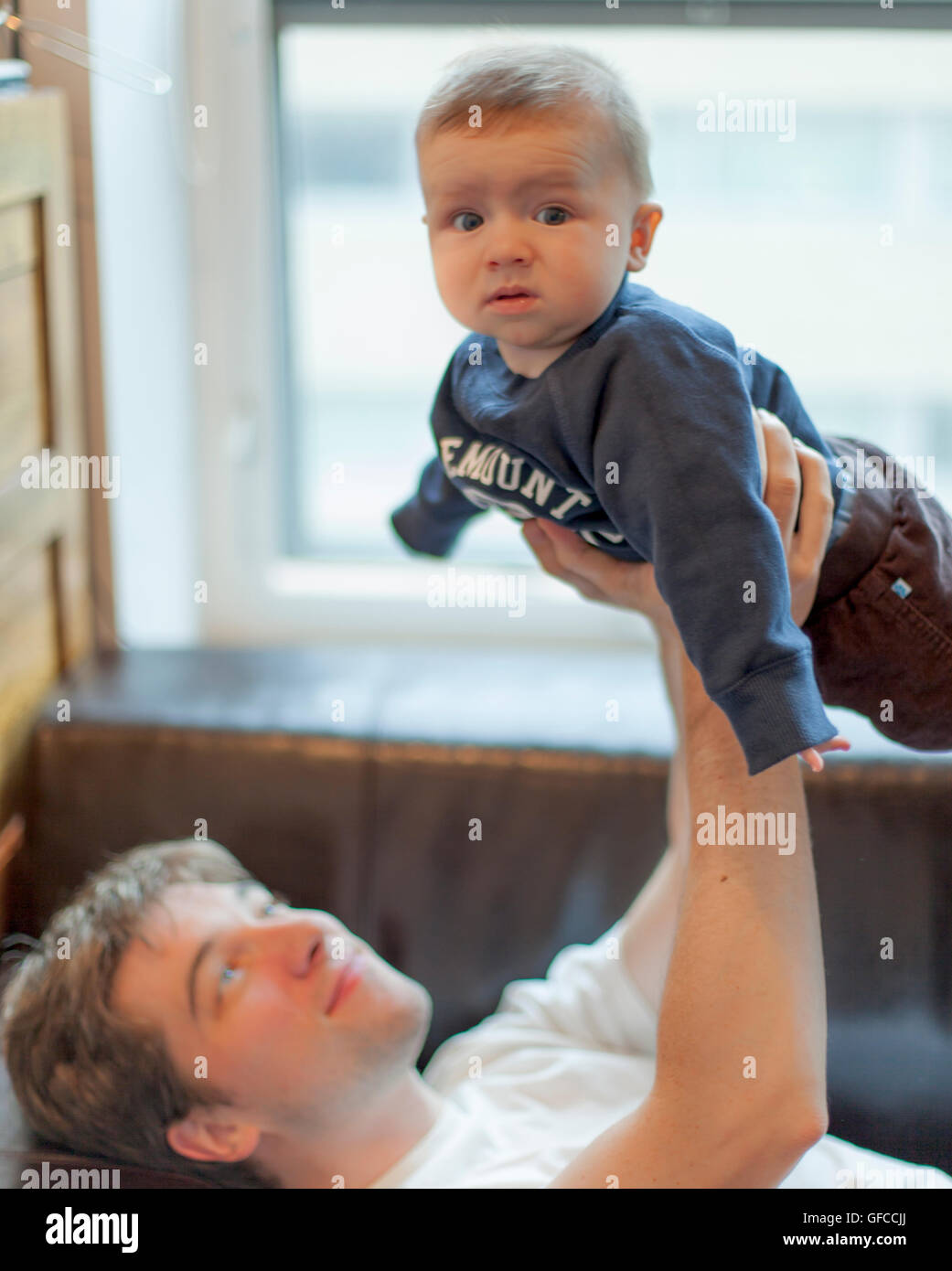 Man playing with his baby son Stock Photo - Alamy