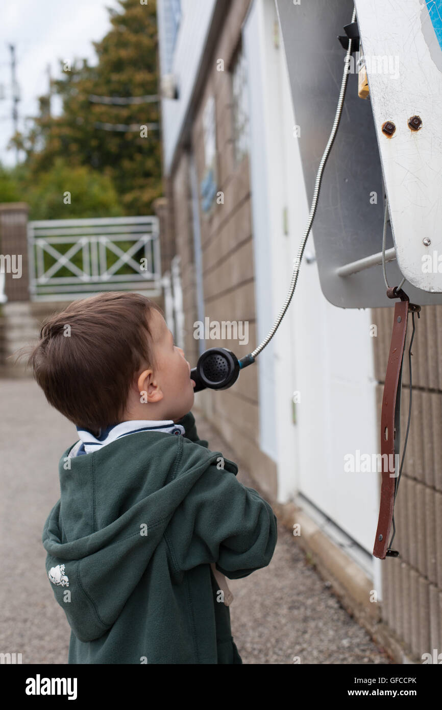 Boy using a public phone Stock Photo - Alamy