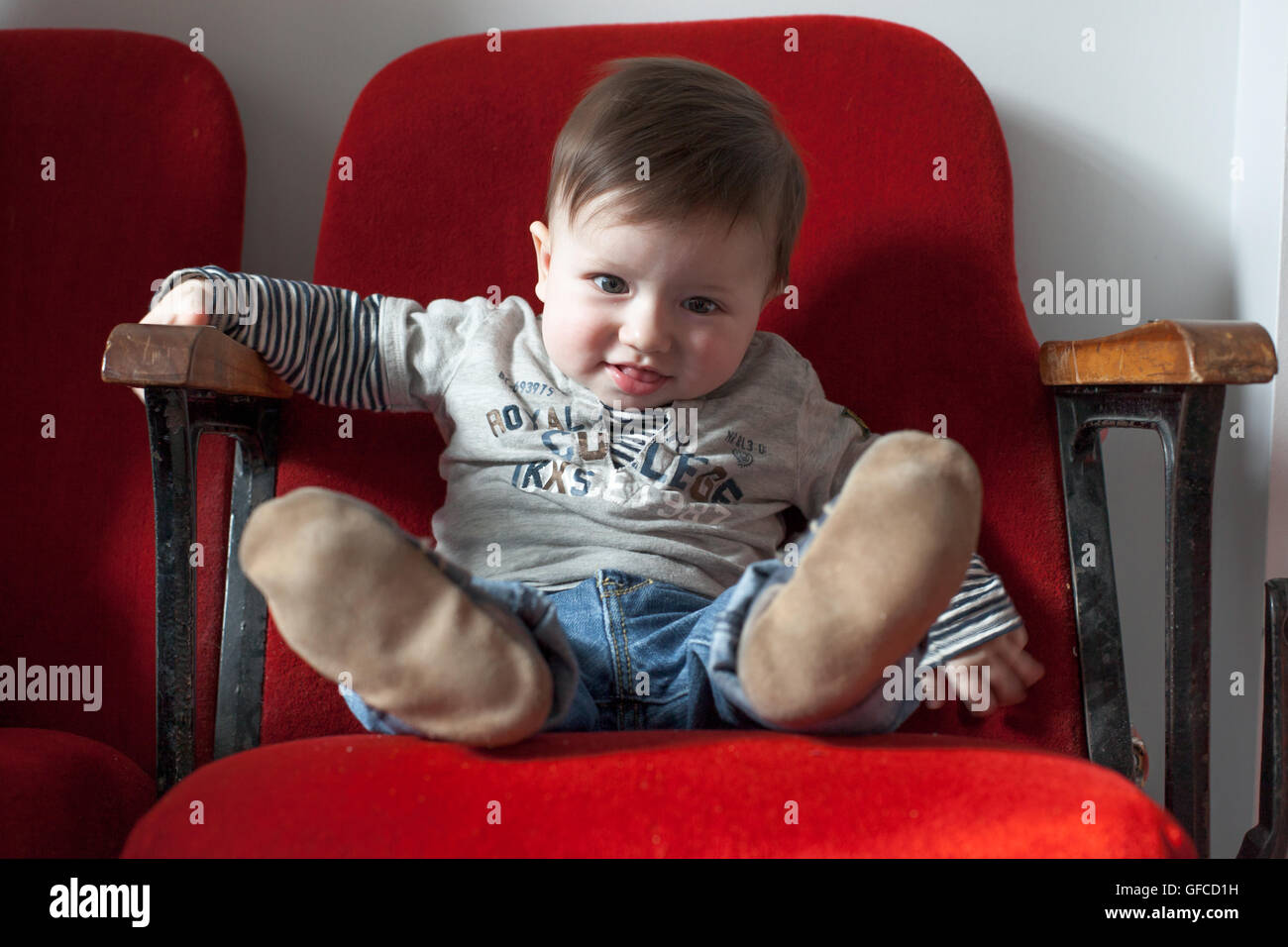 Baby boy sitting on a chair Stock Photo - Alamy