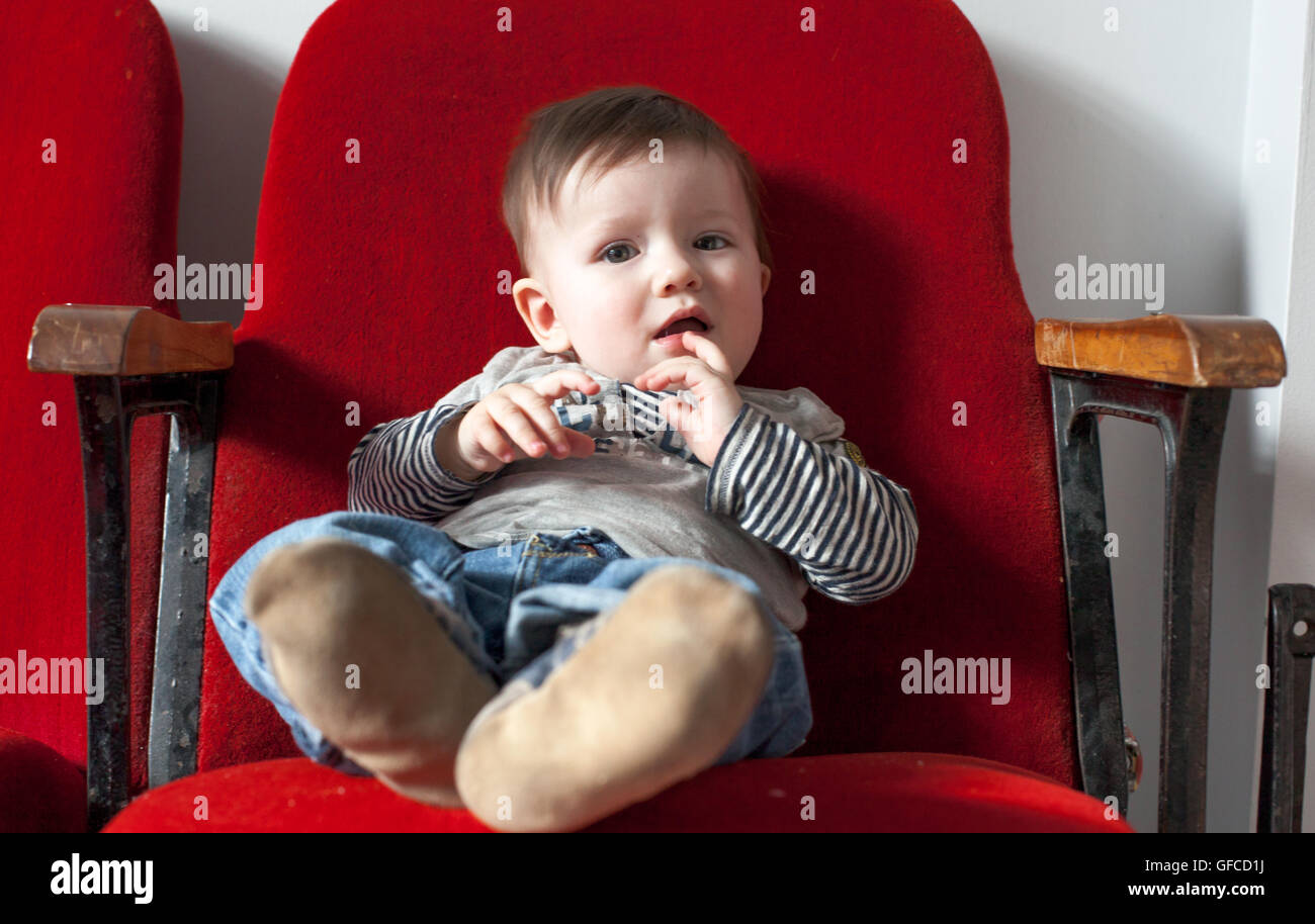 Baby boy sitting on a chair Stock Photo - Alamy
