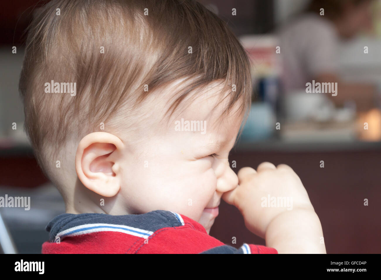 Close-up of a boy rubbing his nose Stock Photo - Alamy