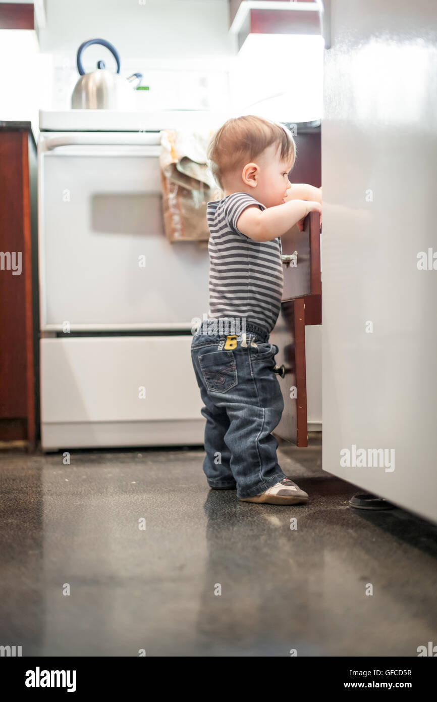 Boy looking in a drawer Stock Photo - Alamy