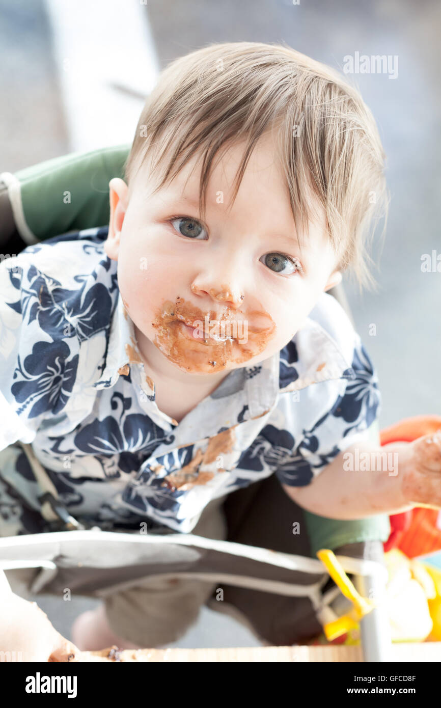Portrait of a boy with cake all over his face Stock Photo - Alamy