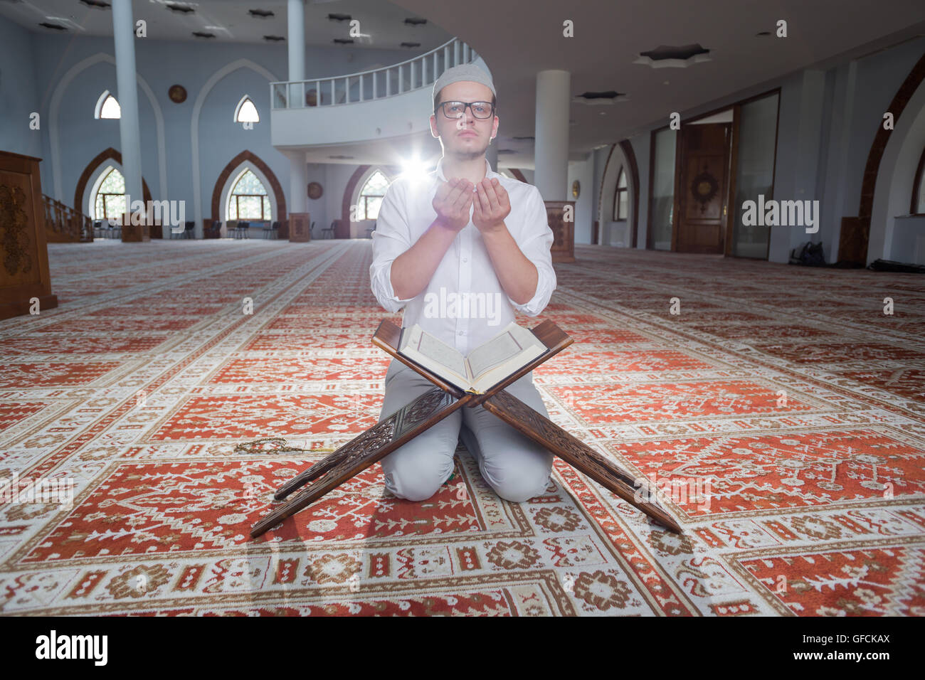 a muslim man is reading quran Stock Photo - Alamy