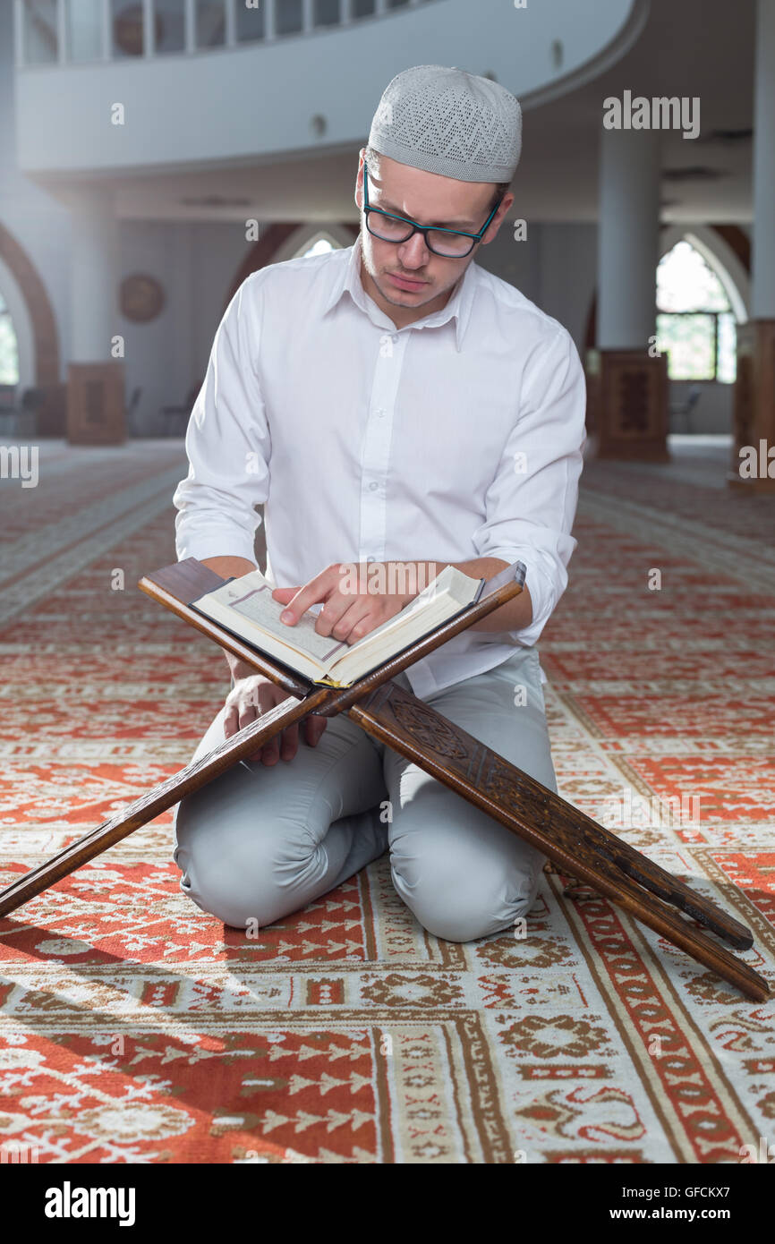 Young Muslim Man Reading The Koran Stock Photo - Alamy